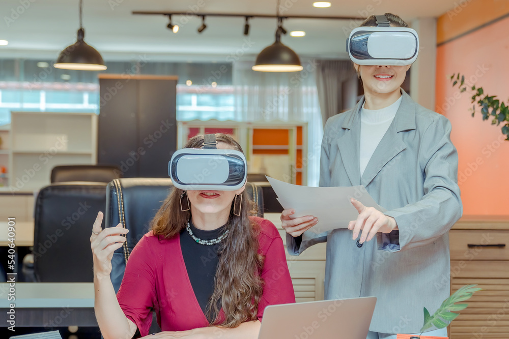 Business woman wearing virtual reality goggles touching air communicate ...