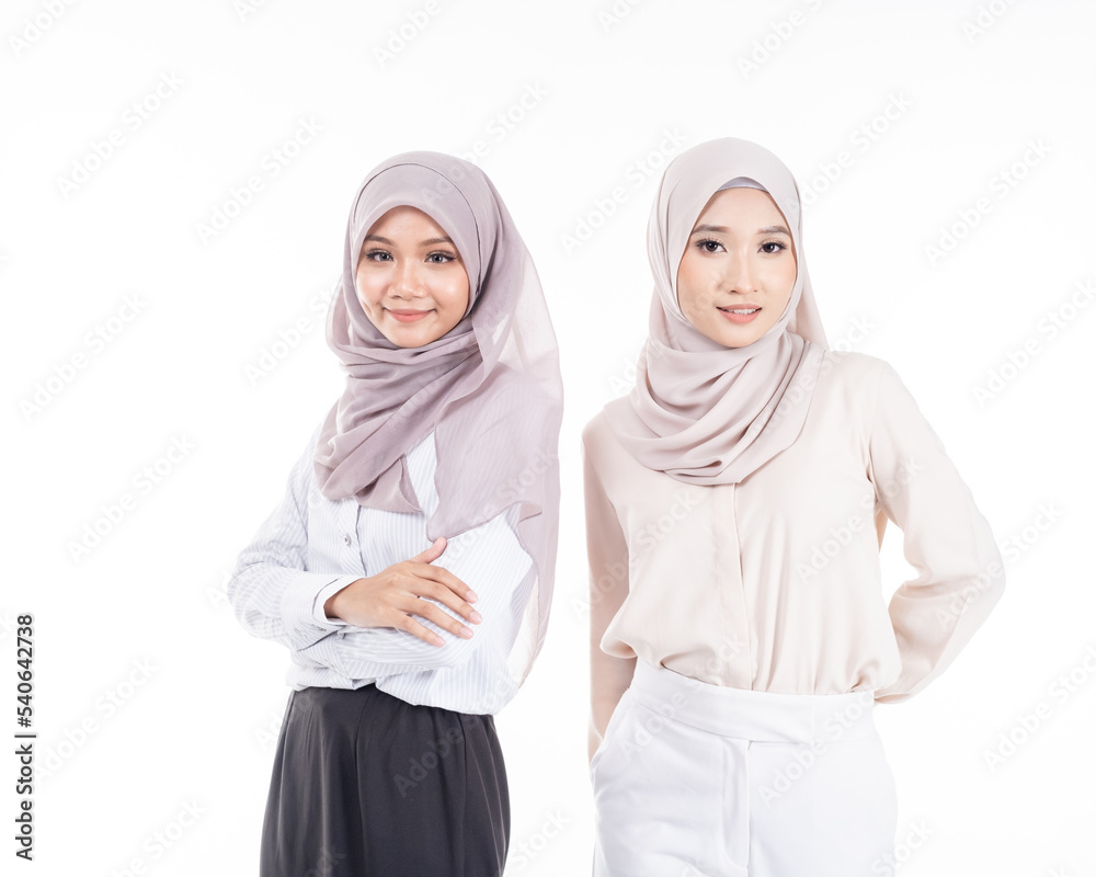 Portrait of two Muslim woman in office attire and wearing a hijab ...