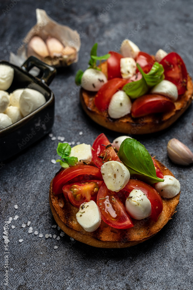 Caprese toasts with mozzarella, cherry tomatoes and fresh garden basil ...