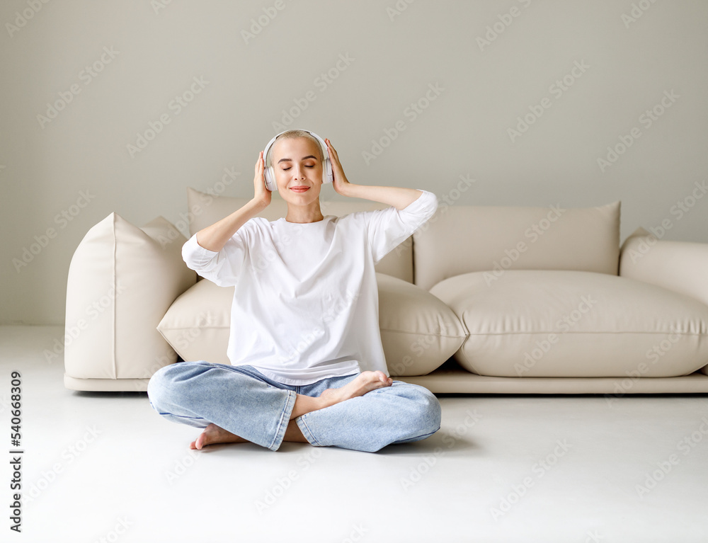 Beautiful woman meloman with very short hair listens to music near ...