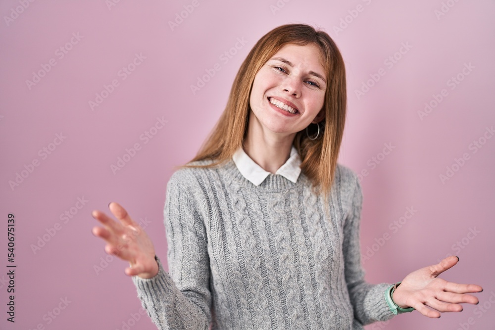 Beautiful woman standing over pink background smiling cheerful with ...