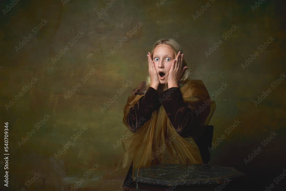 Shocked young girl with long blonde hair wearing medieval dress like ...
