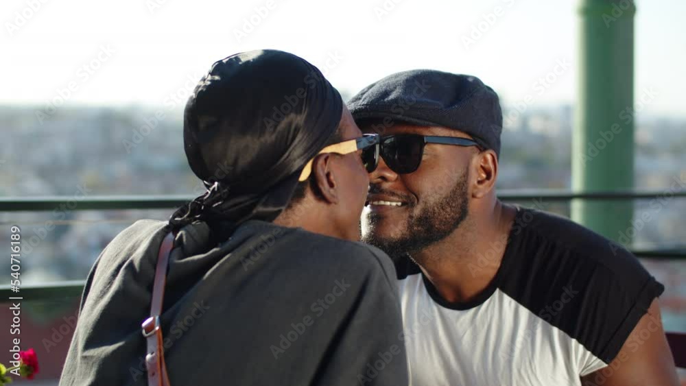 Close-up shot of bearded gay kissing his lover on rooftop. African ...