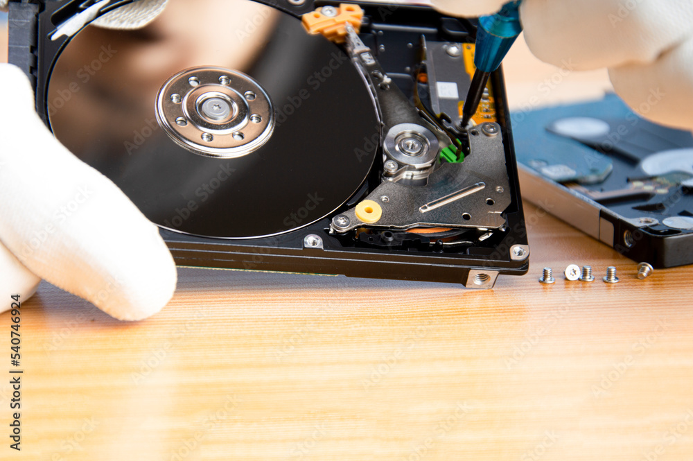 mechanic repairing hard drive, hard drive It is a device for storing ...