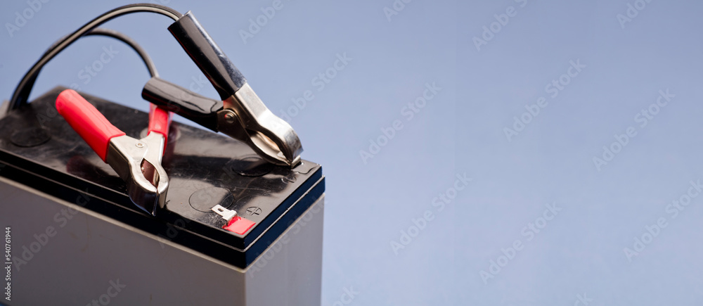 connected bolts charging battery positive pole and negative pole, blue ...