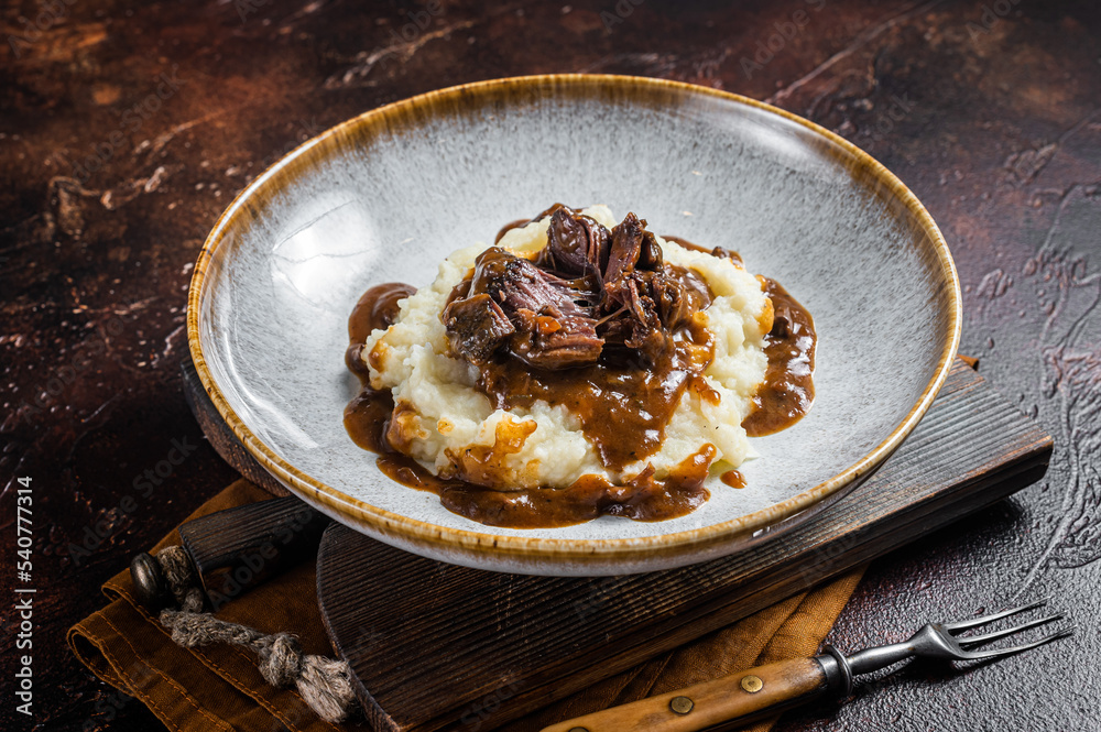 Slow cooked beef cheeks in red wine sauce with mashed potato. Dark ...