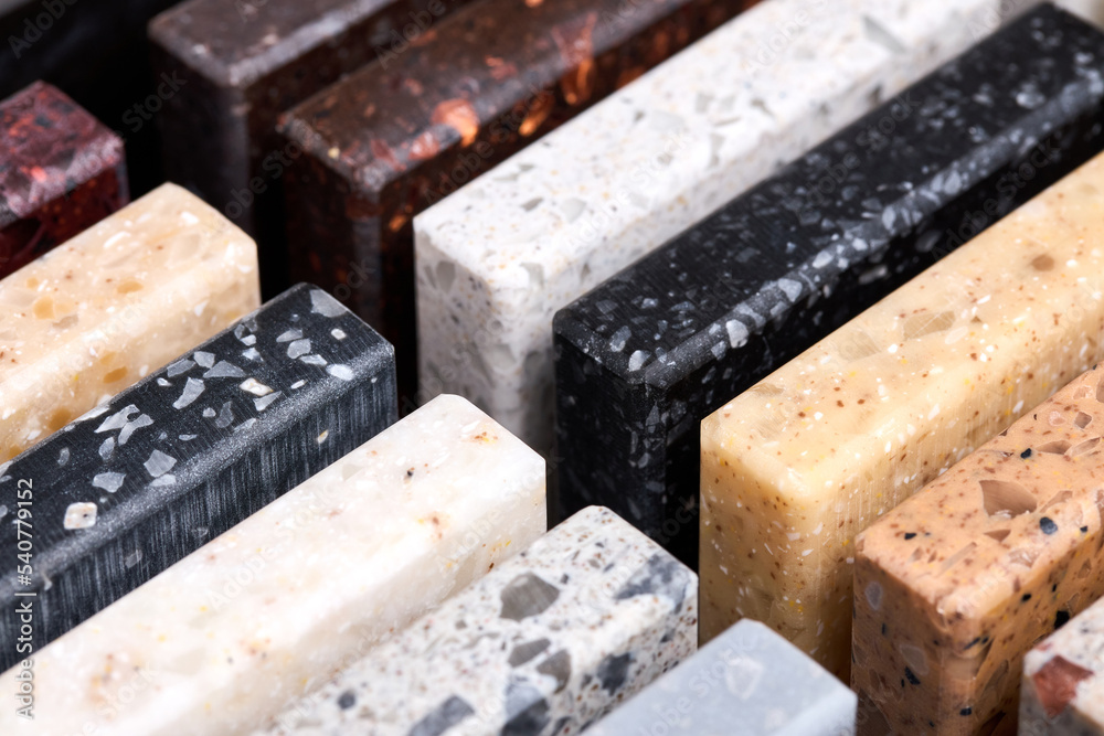 Porcelain stoneware square samples laid on kitchen countertop as ...