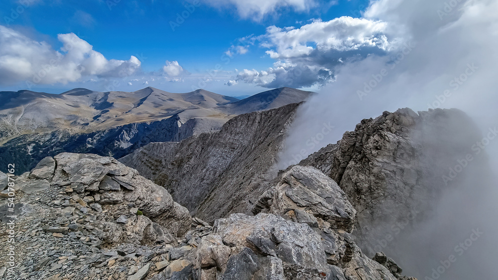 Panoramic view from cloud covered mountain summit of Mytikas Mount ...