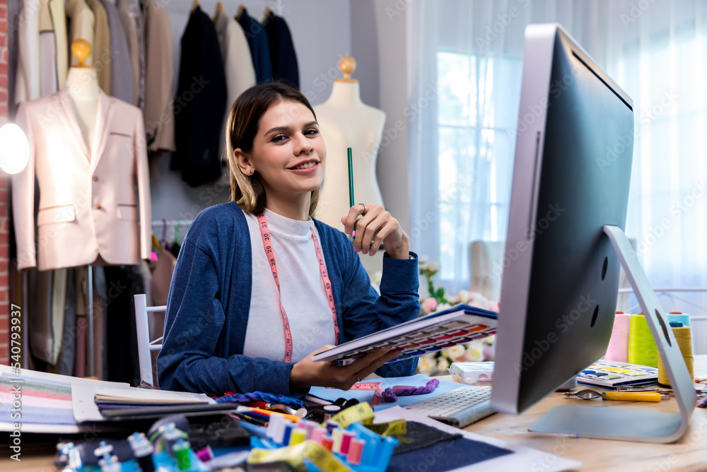 Professional fashion designer woman using Computer or laptop at the ...