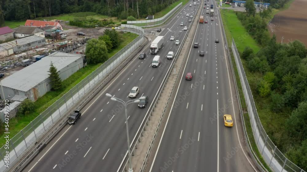 Traffic on wide rural motorway across forest with construction site and ...