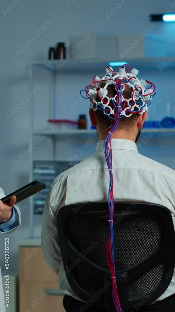 Vertical video: Man patient wearing performant eeg headset scanning ...