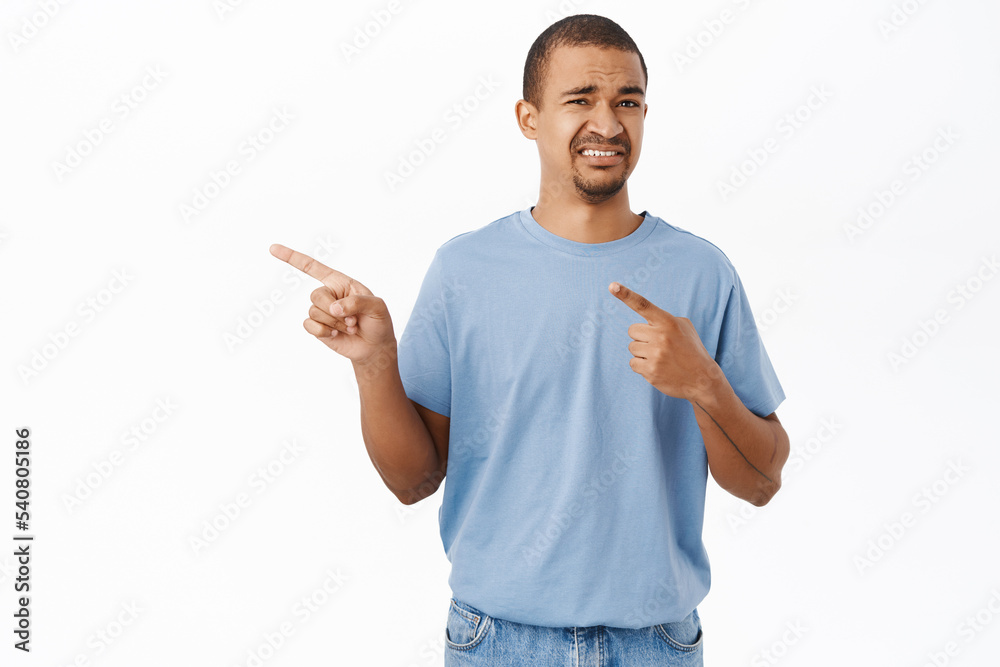 Phew cringe. Disgusted guy pointing fingers left, grimacing and looking ...