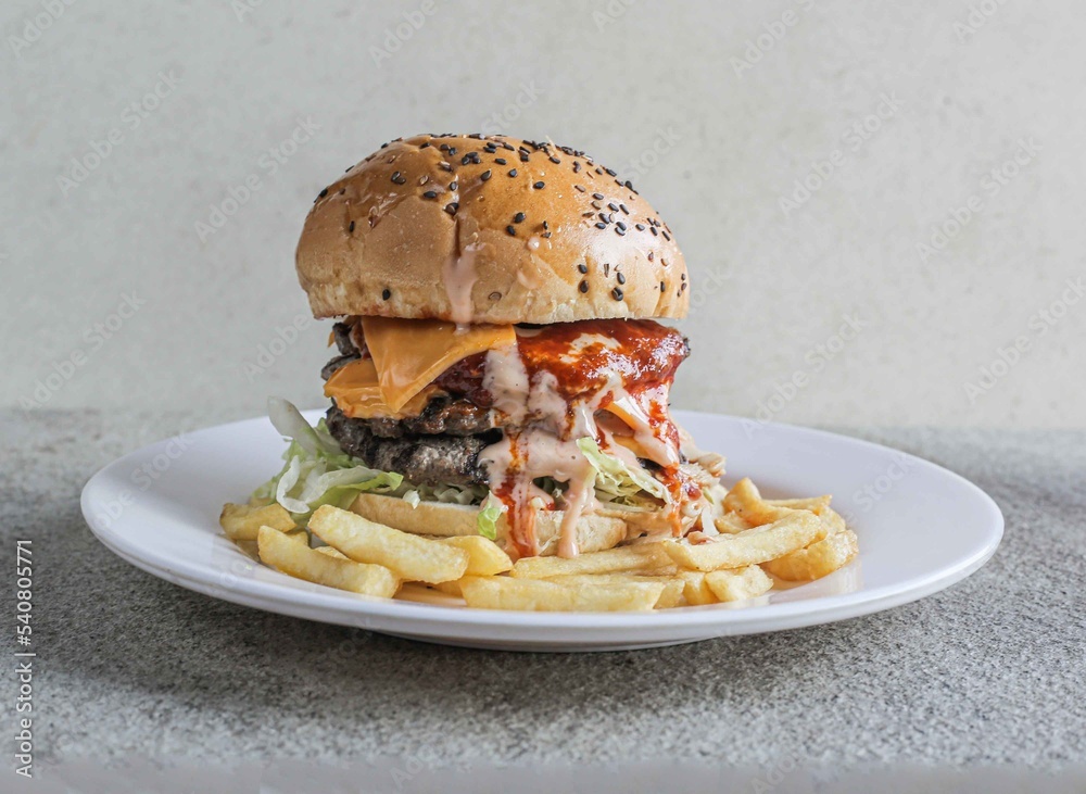Double beef cheese burger with fries served in a dish isolated on grey ...