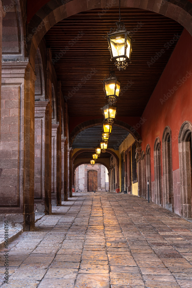 Rustic hallway with arches and lanterns n the historic center of the ...