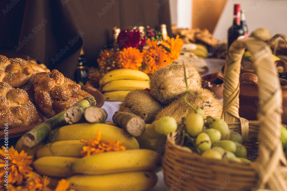 Traditional Mexican Day of the Dead altar with offerings of cempasuchil ...