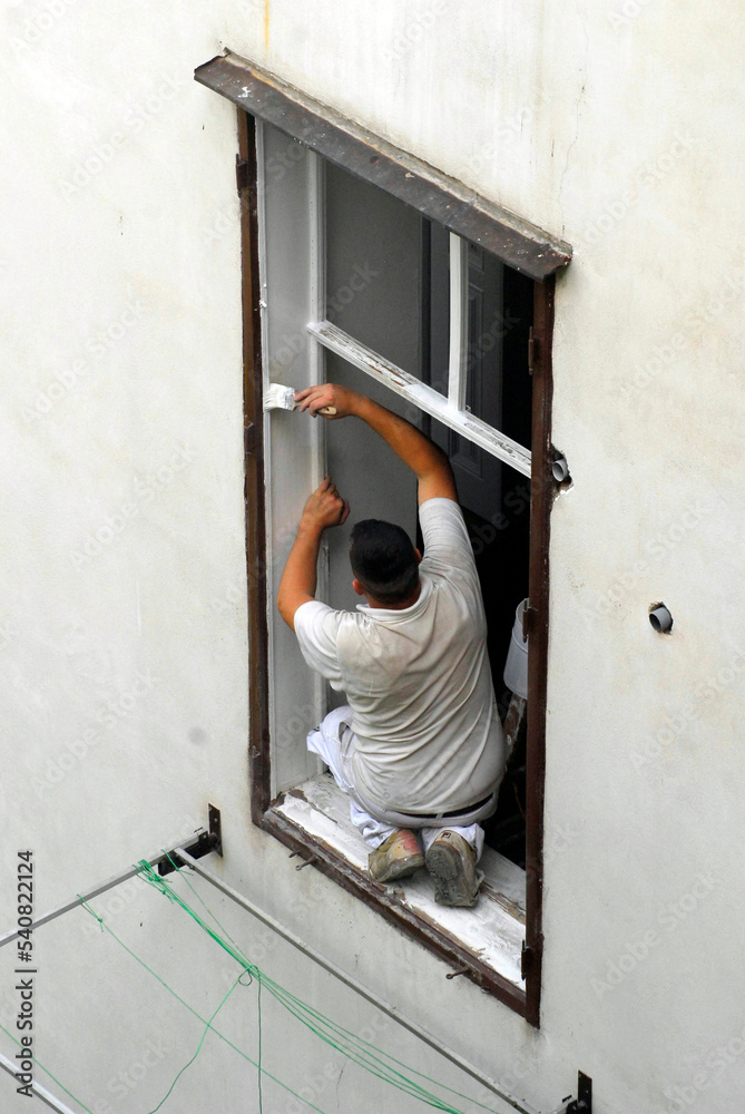 painter painting the window of a building Stock Photo | Adobe Stock