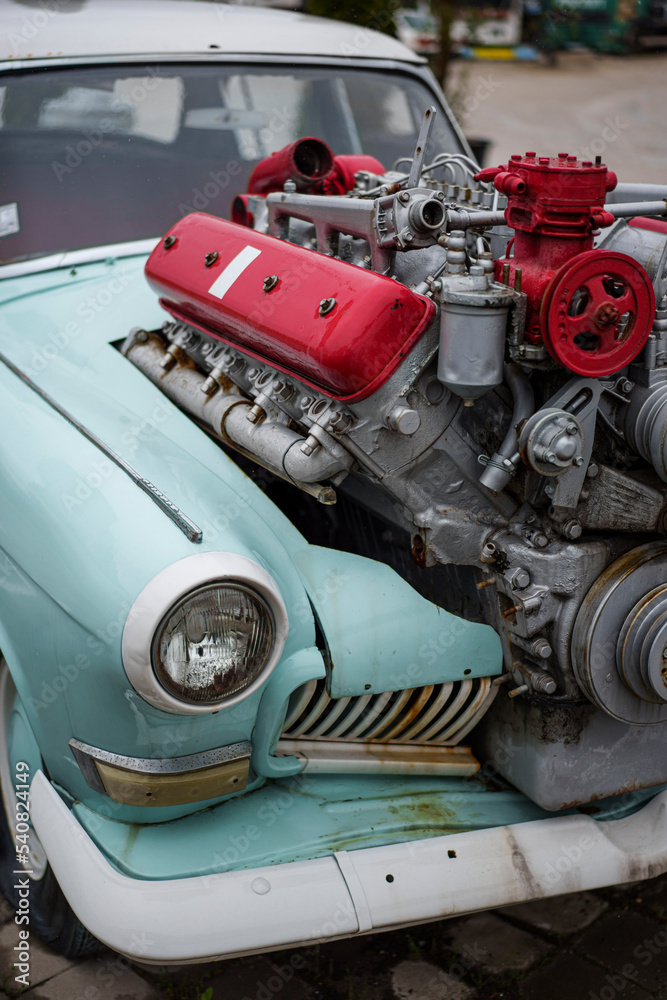 Vintage tuned car, with a large engine sticking out of its hood Stock ...