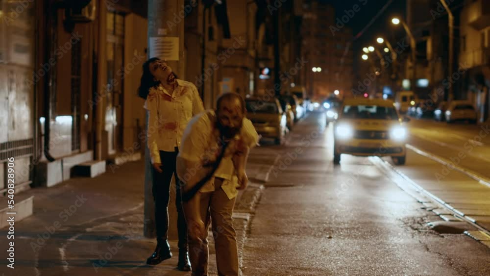 Creepy looking office zombies wandering on sidewalks of city at night ...