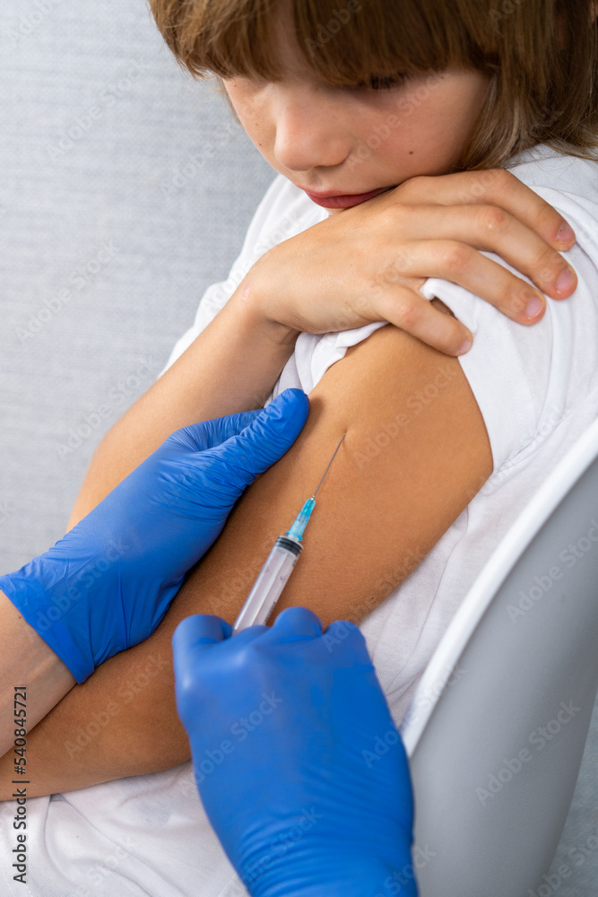 vaccination of children, a little boy at a doctor's appointment, an ...