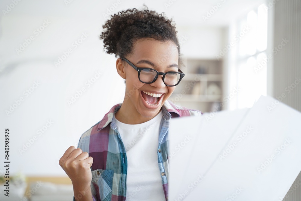 Happy african american girl student celebrating achievement, holding ...