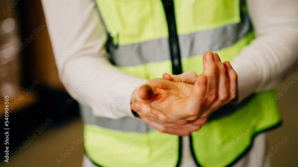 Hardworking male warehouse engineer suffering from hand injury during ...