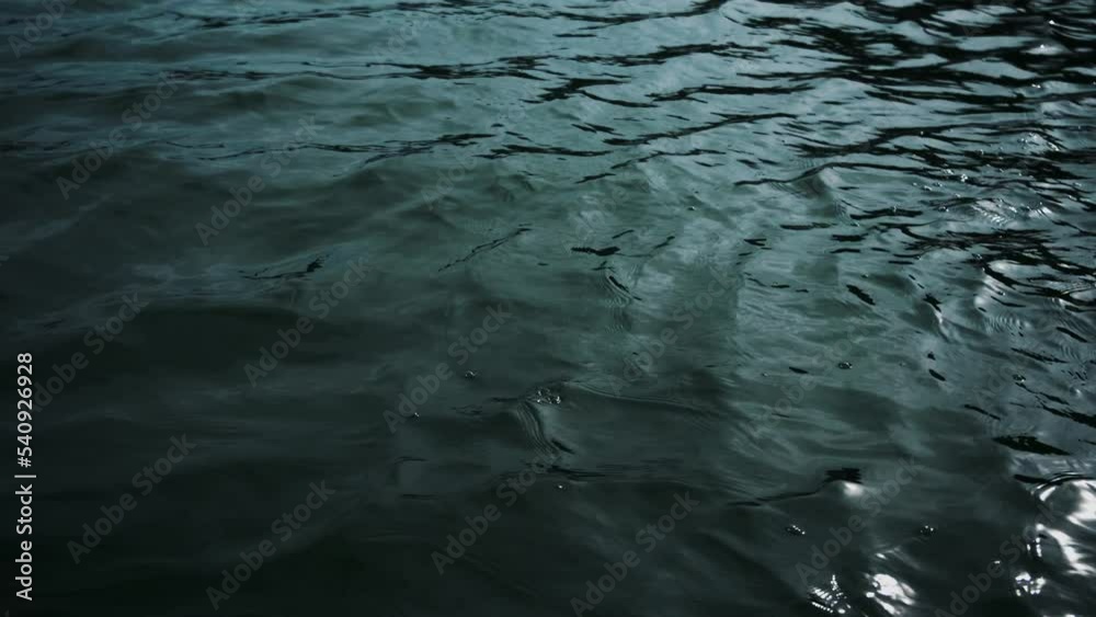 Dark water in the sea. Boat acceleration. Water begins to foam ...