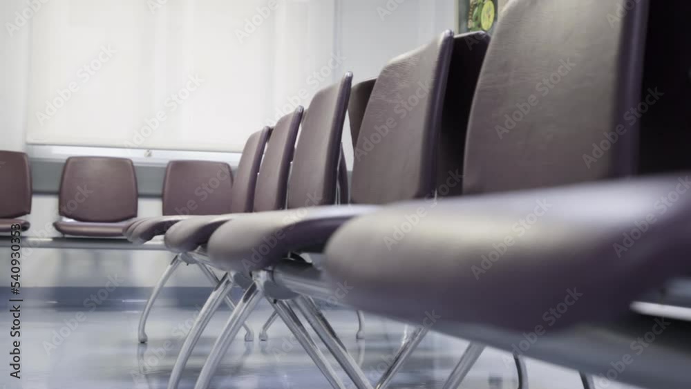 empty waiting room of private building showing line of chair in clean ...