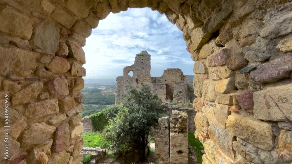 View through a window of a destroyed medieval castle in Spain Palafolls ...