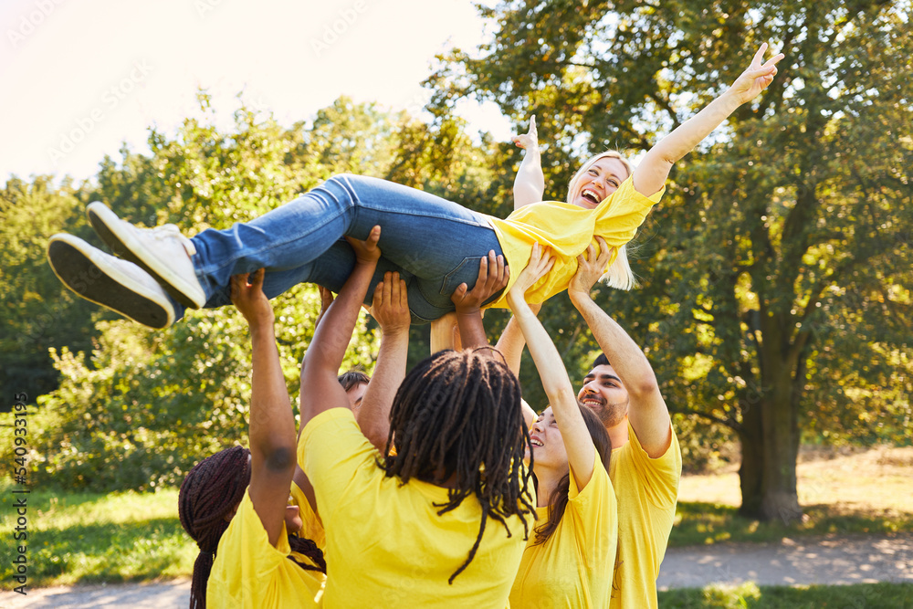 Group of young people lifts up woman together Stock Photo | Adobe Stock