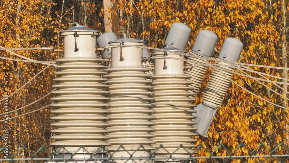 Power lines with sun rays on blue sky. High voltage substation ...