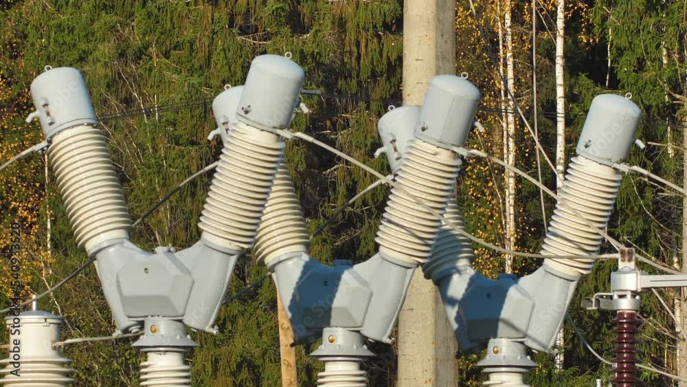 Power lines with sun rays on blue sky. High voltage substation ...