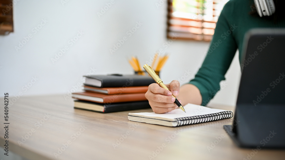Female writing or taking notes on her spiral notebook. close-up and ...