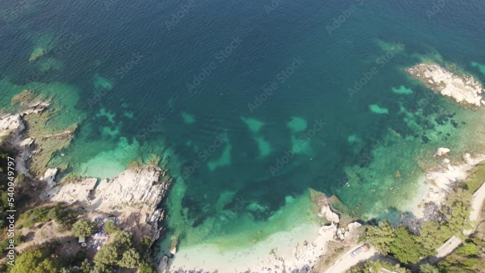 Drone pullback over idyllic beaches and coastline of Kassiopi, Corfu ...