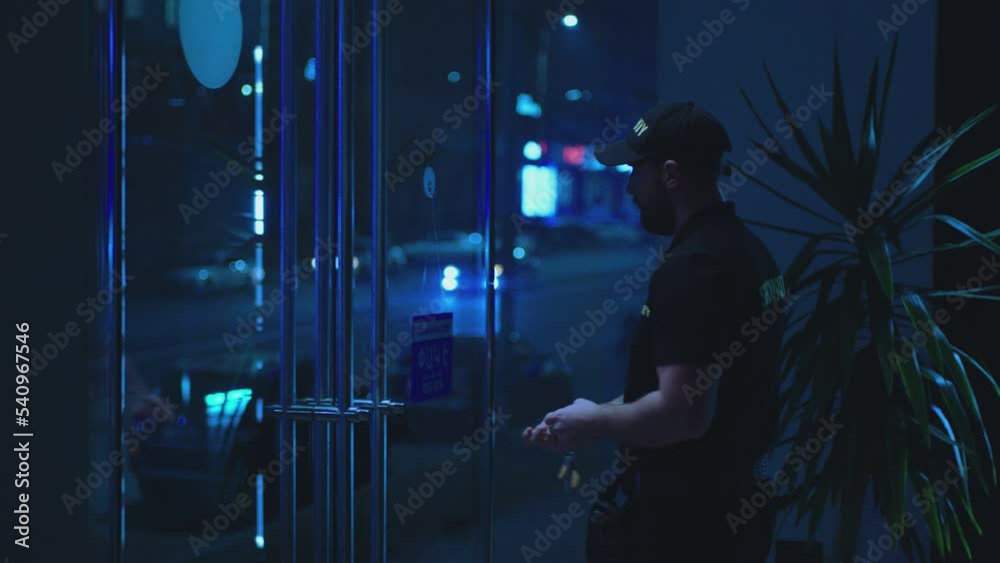 Guard or security worker walking , closing door and turning plate with ...