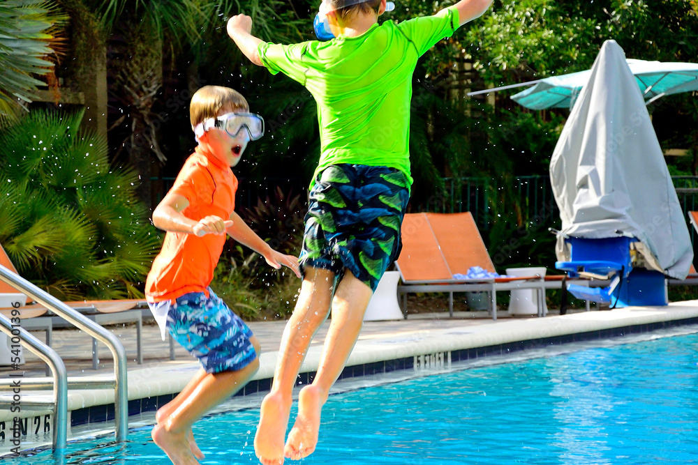 Kids jumping in swimming pool Stock Photo | Adobe Stock