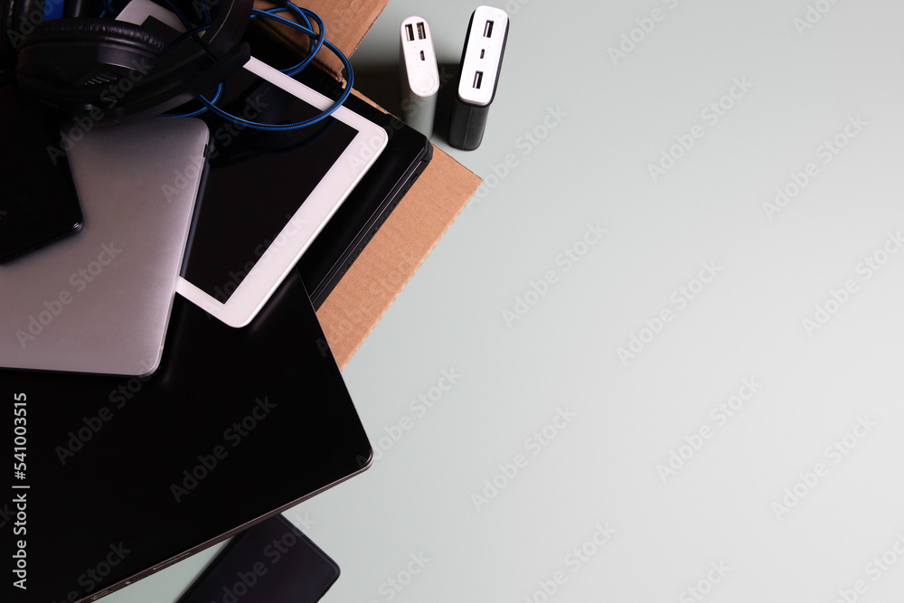 Cardboard box full of old used laptop computers, digital tablets ...