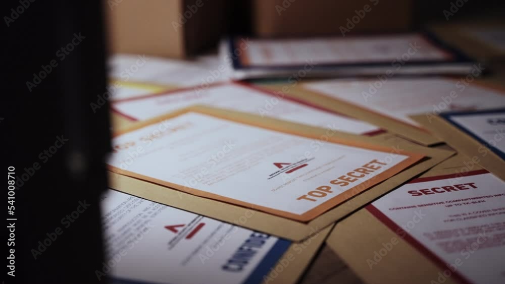 Many envelops with top secret material are on a desk or floor after ...