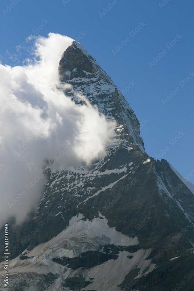 The sharp pyramid shape of the Matterhorn, a famous mountain above ...