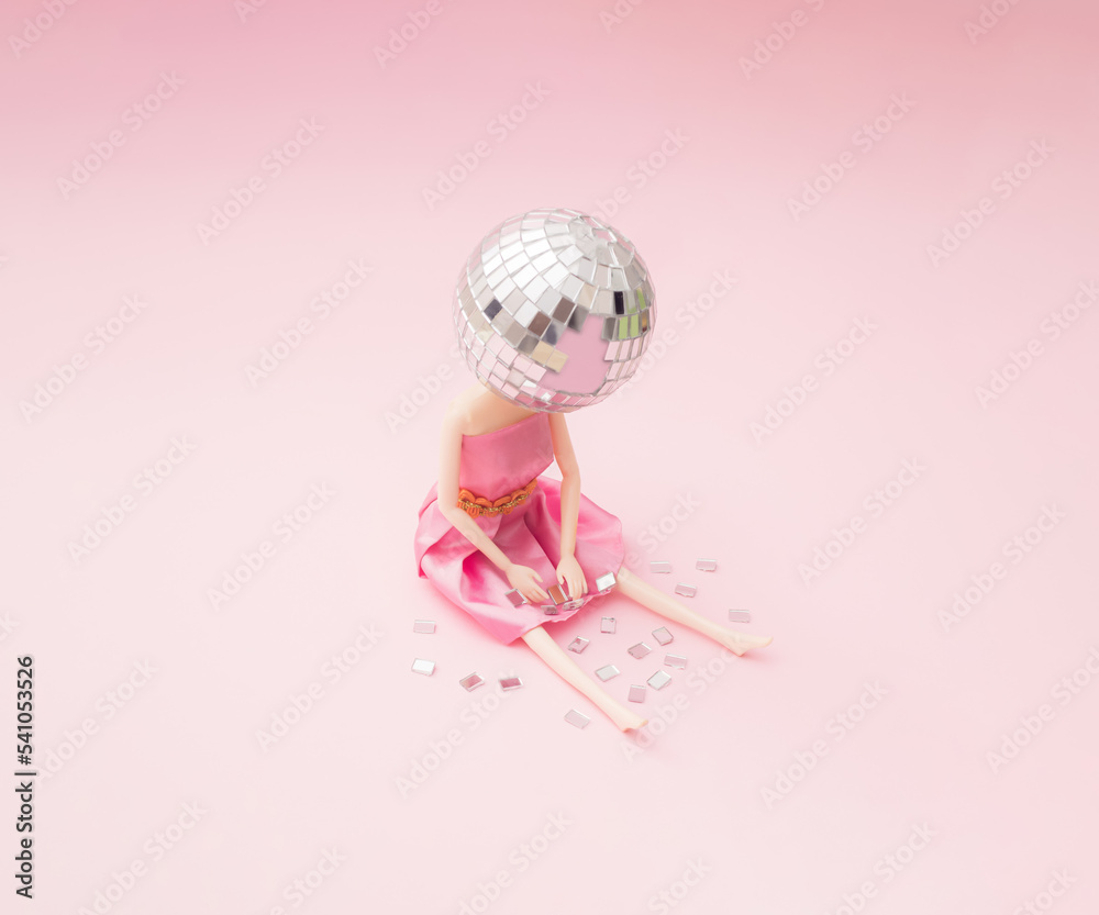 Sad girl in a pink dress sits on a pastel background with a broken ...