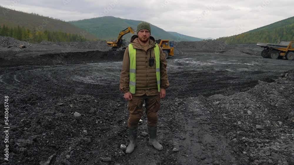 Mining Site Worker On Rock Pile With Industrial Excavation Equipment ...