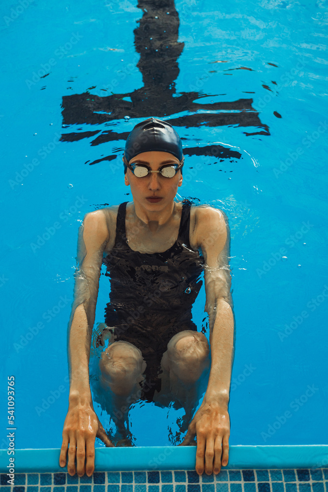From above of focused professional female swimmer getting ready to ...