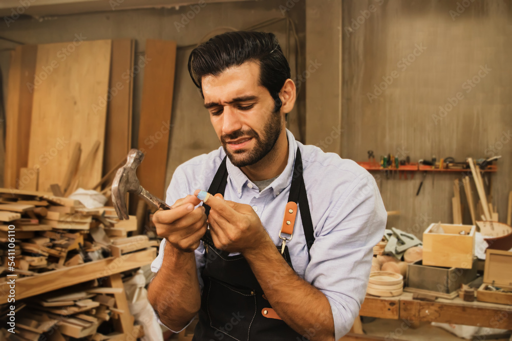 Carpenter worker in a furniture factory Cried in pain from the accident ...
