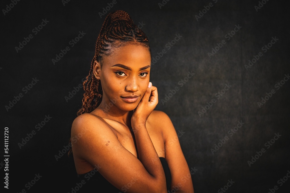 Black South African Teenage Girl Staring Intently Into The Camera While Smirking Photos Adobe