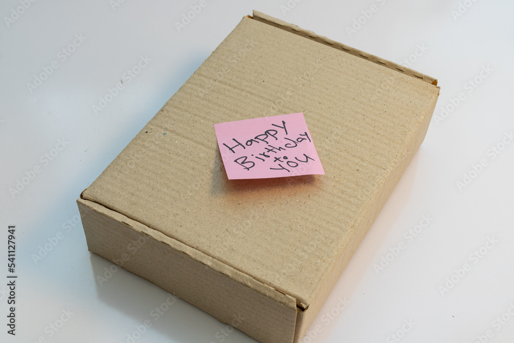 Parcel box with a text memo of Happy birthday to you written on a ...