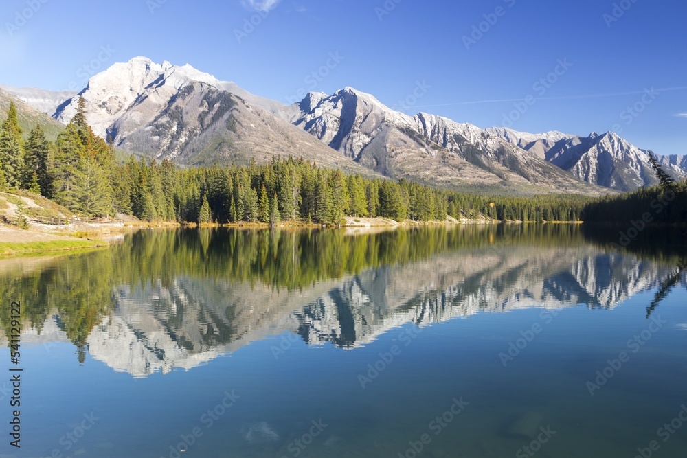 Mountain Range and Green Forest Trees Reflected in Calm Lake Water ...