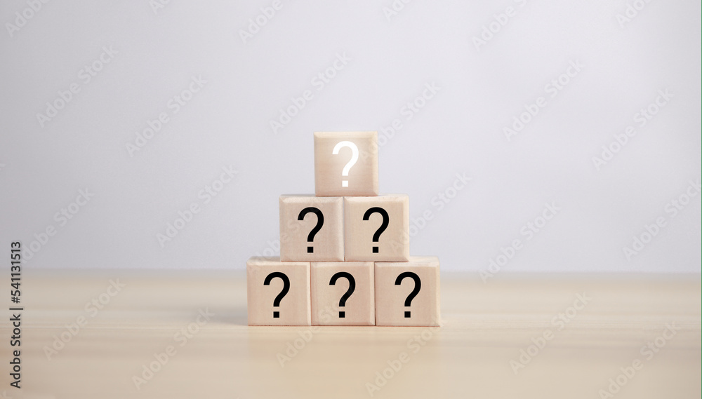 A wooden cube block showing a question mark icon. concept alternative ...