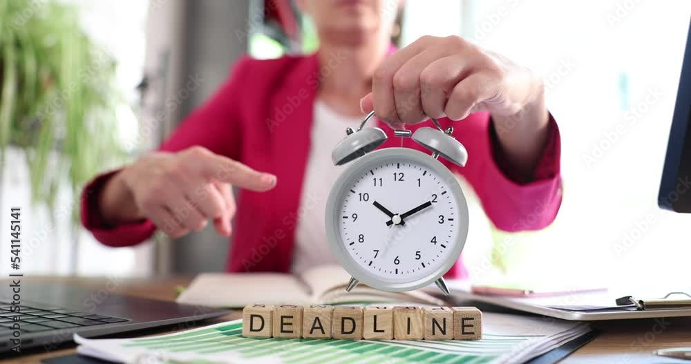 Business woman with alarm clock in hand and text submission deadline on ...