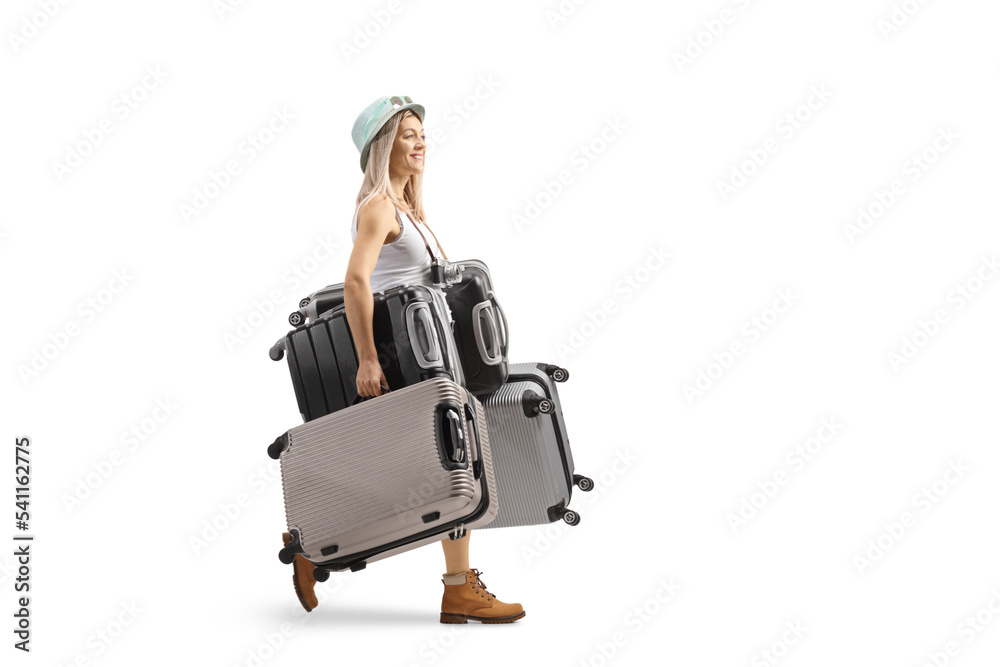 Full length profile shot of a young woman walking and carrying many ...