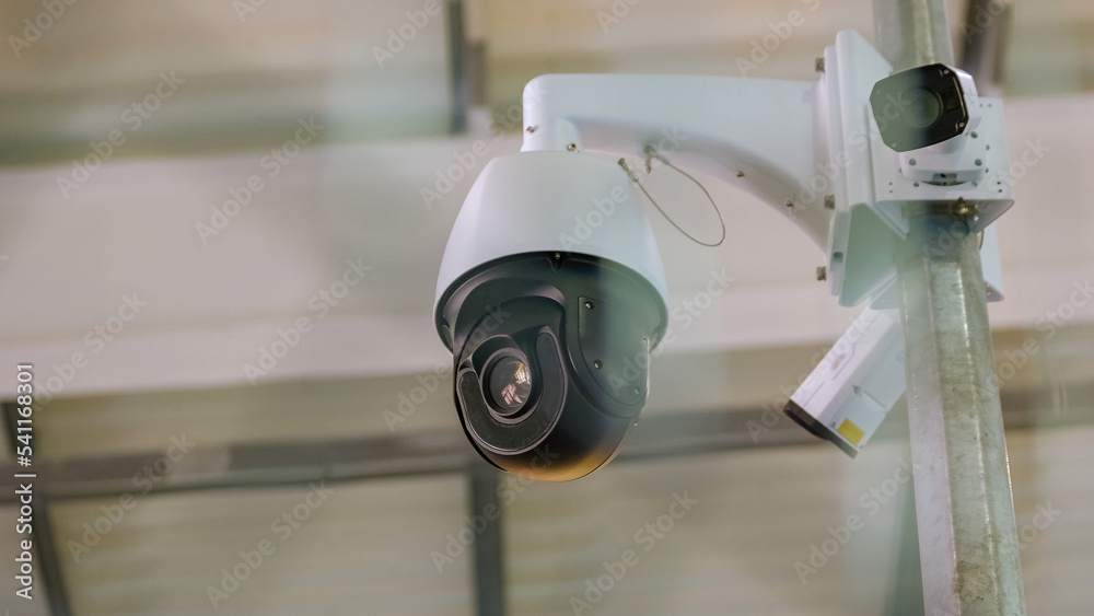 Black surveillance video camera turning to the right. Control camera ...
