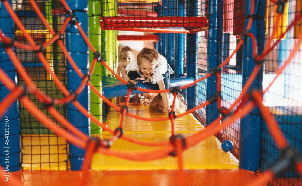 Happy group of siblings crawling and playing together in indoor ...